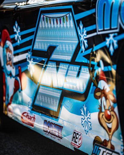 Christmas themed race cars at the Snowball Derby - Official Site Of NASCAR